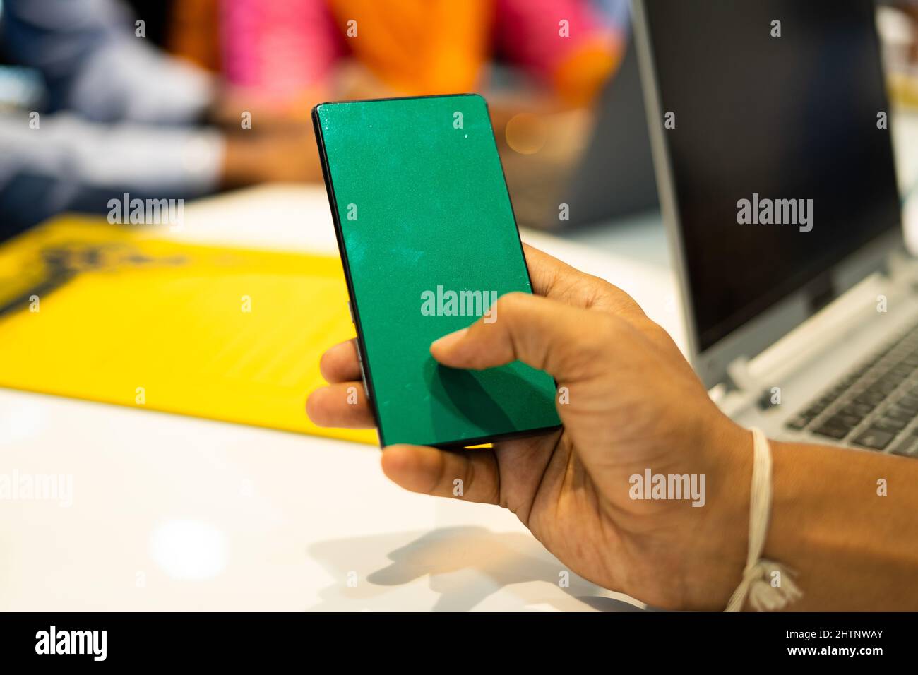 close up shot of employee hands using green screen mobile phone at ...