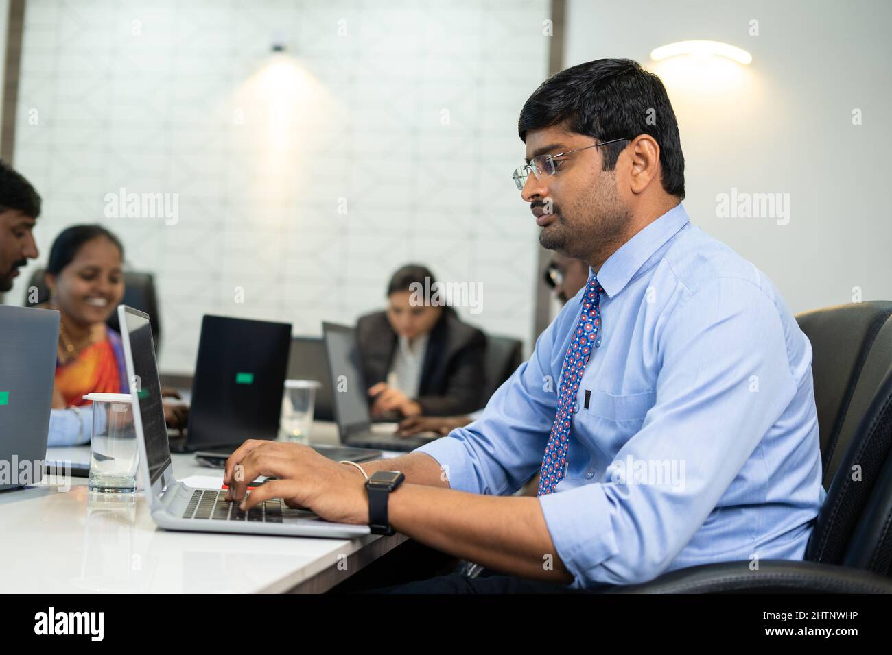 employee busy working on laptop during business meeting at office ...