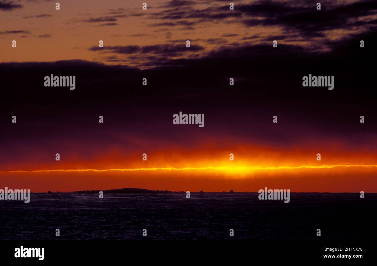 Bright evening sunshine through a gap in the clouds, analog. Islands ...