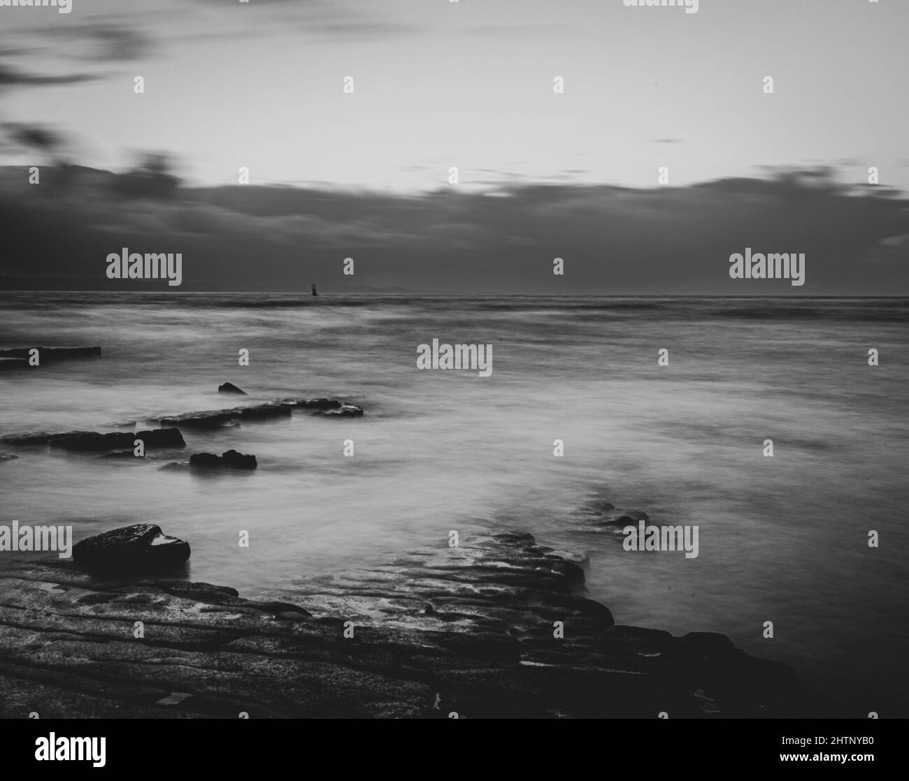 Grayscale view of a seashore of a stormy sea Stock Photo - Alamy