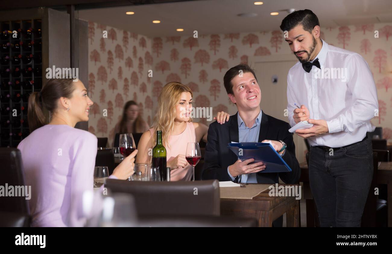 Adult waiter taking order in restaurant Stock Photo - Alamy