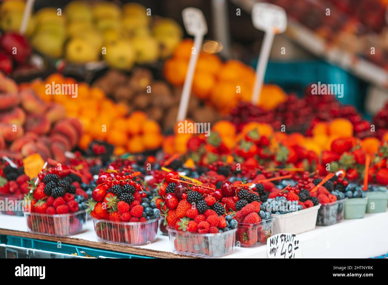 Fruits and berries on the street market. Blueberries, raspberries ...