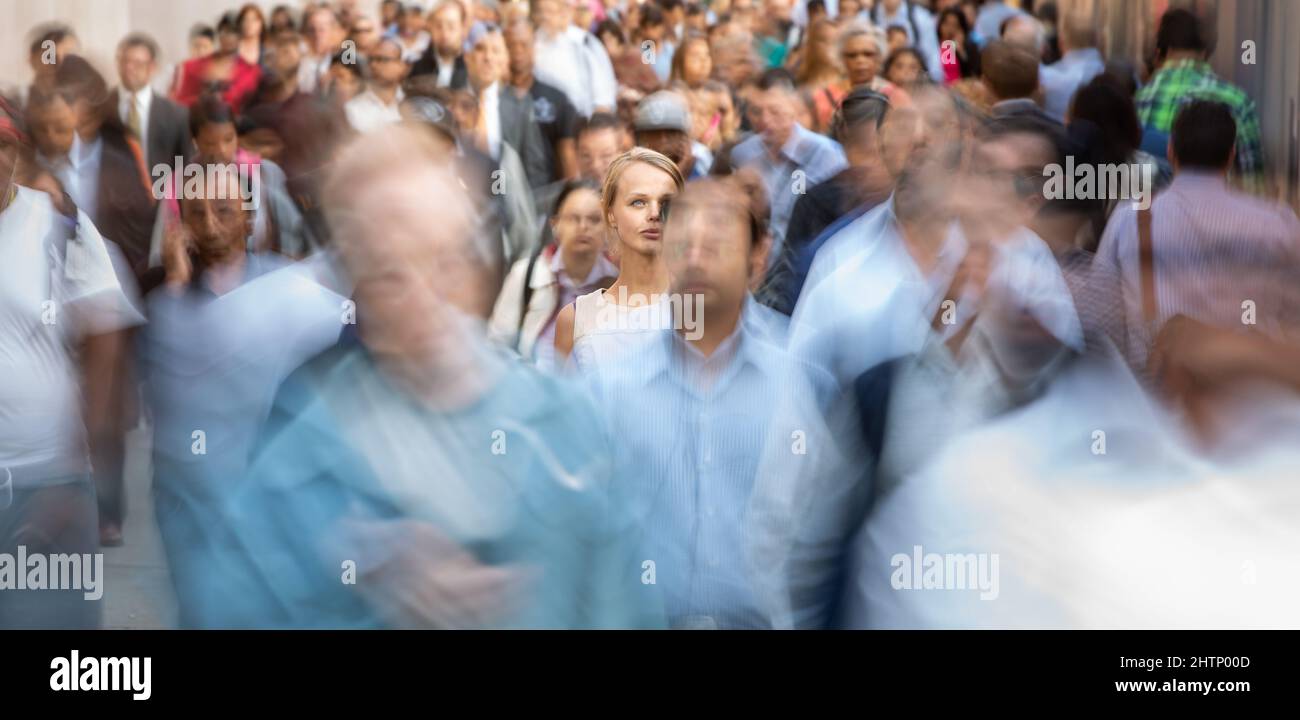 Crowd of people walking on city street - motion blurred image with ...