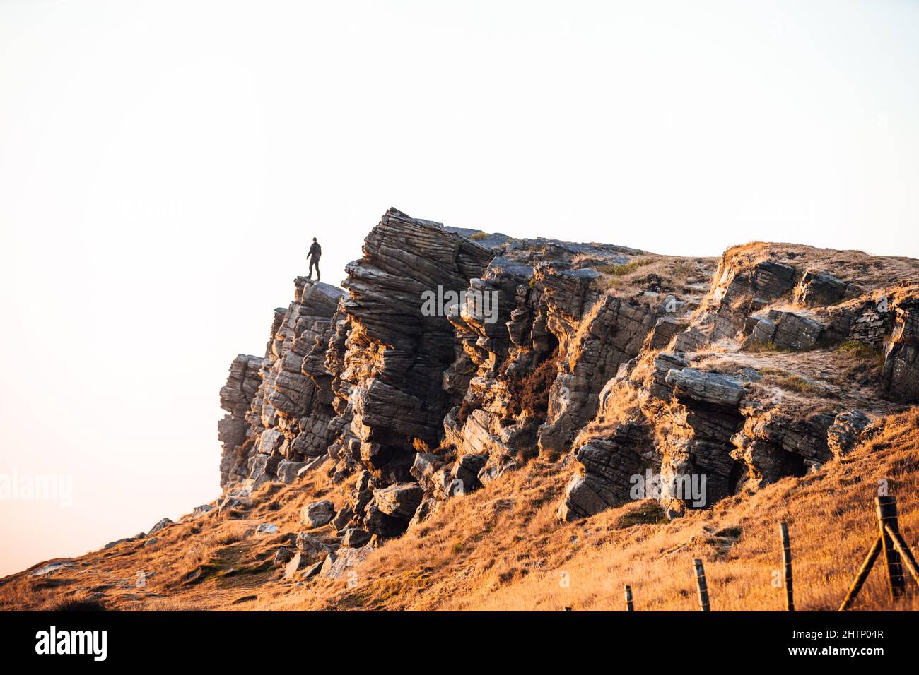 Man standing on huge rock Stock Photo - Alamy