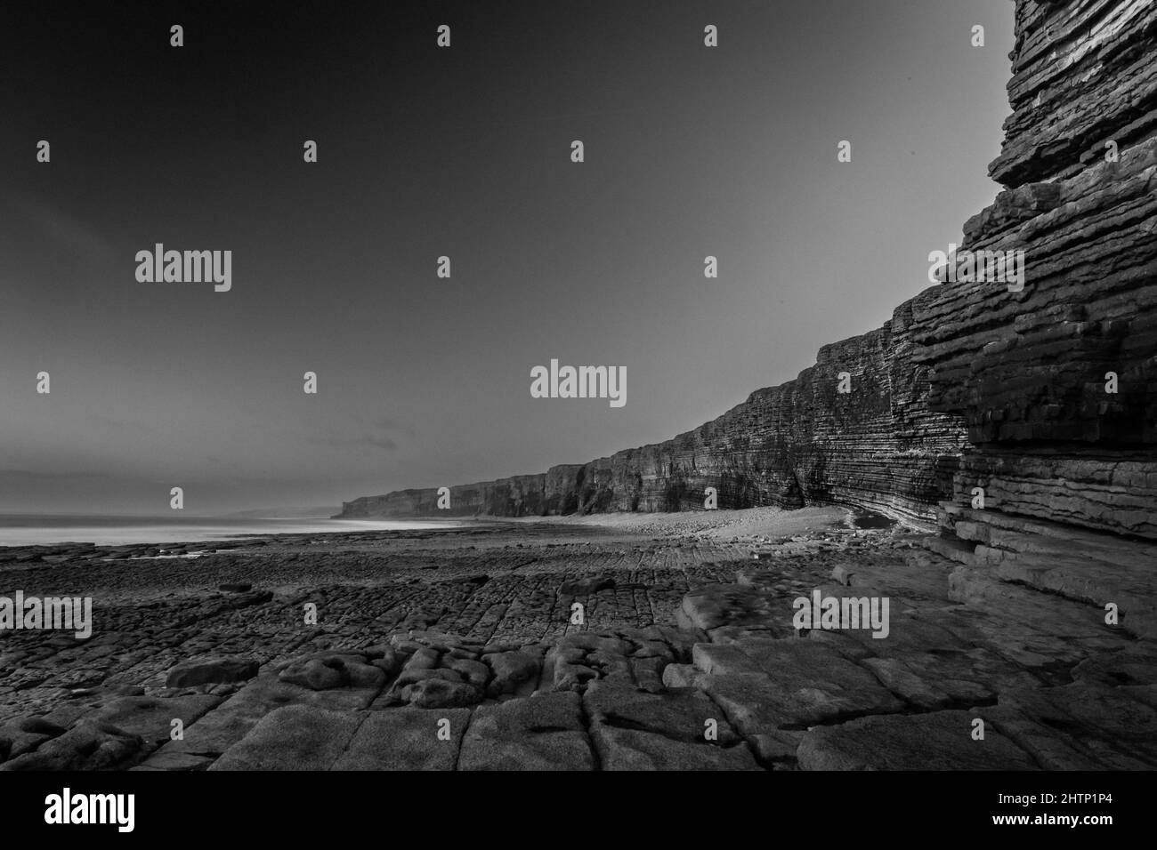 Grayscale shot of a natural landscape of cliffs and sea Stock Photo - Alamy