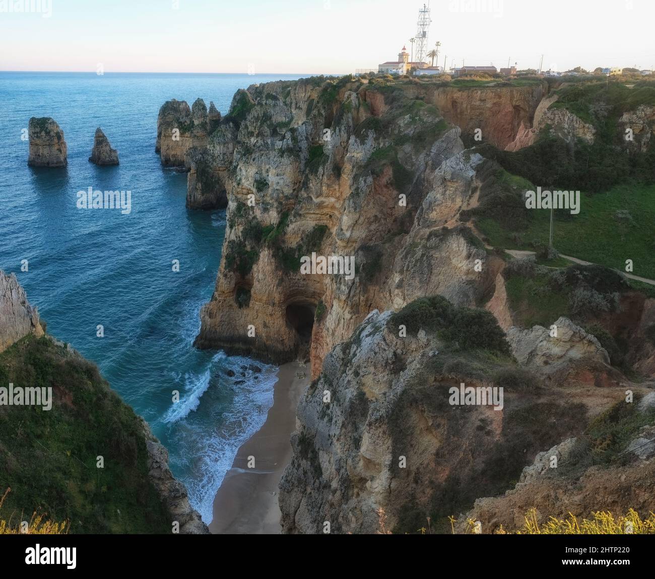 Lighthouse on rocks on the coast of the Atlantic Ocean in city of Lagos ...