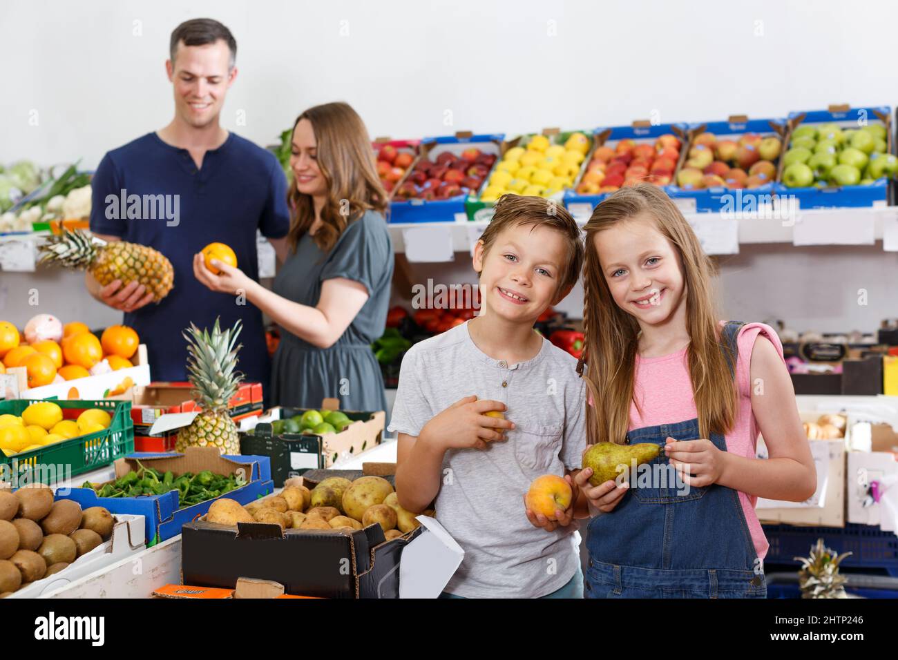Two glad kids looking for delicious fruits Stock Photo - Alamy