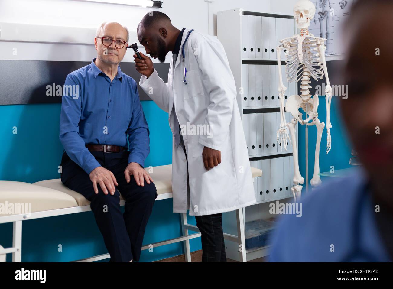 Specialist otologist man doctor checking ear infection using medical ...