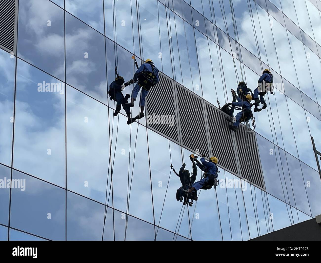 Workers cleaning glass windows Stock Photo - Alamy