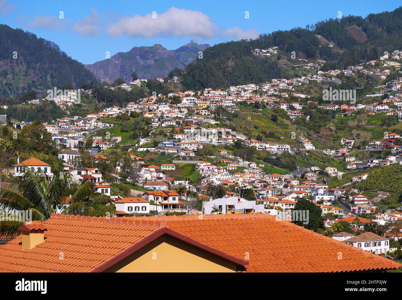 Hillside village near mountains Stock Photo - Alamy
