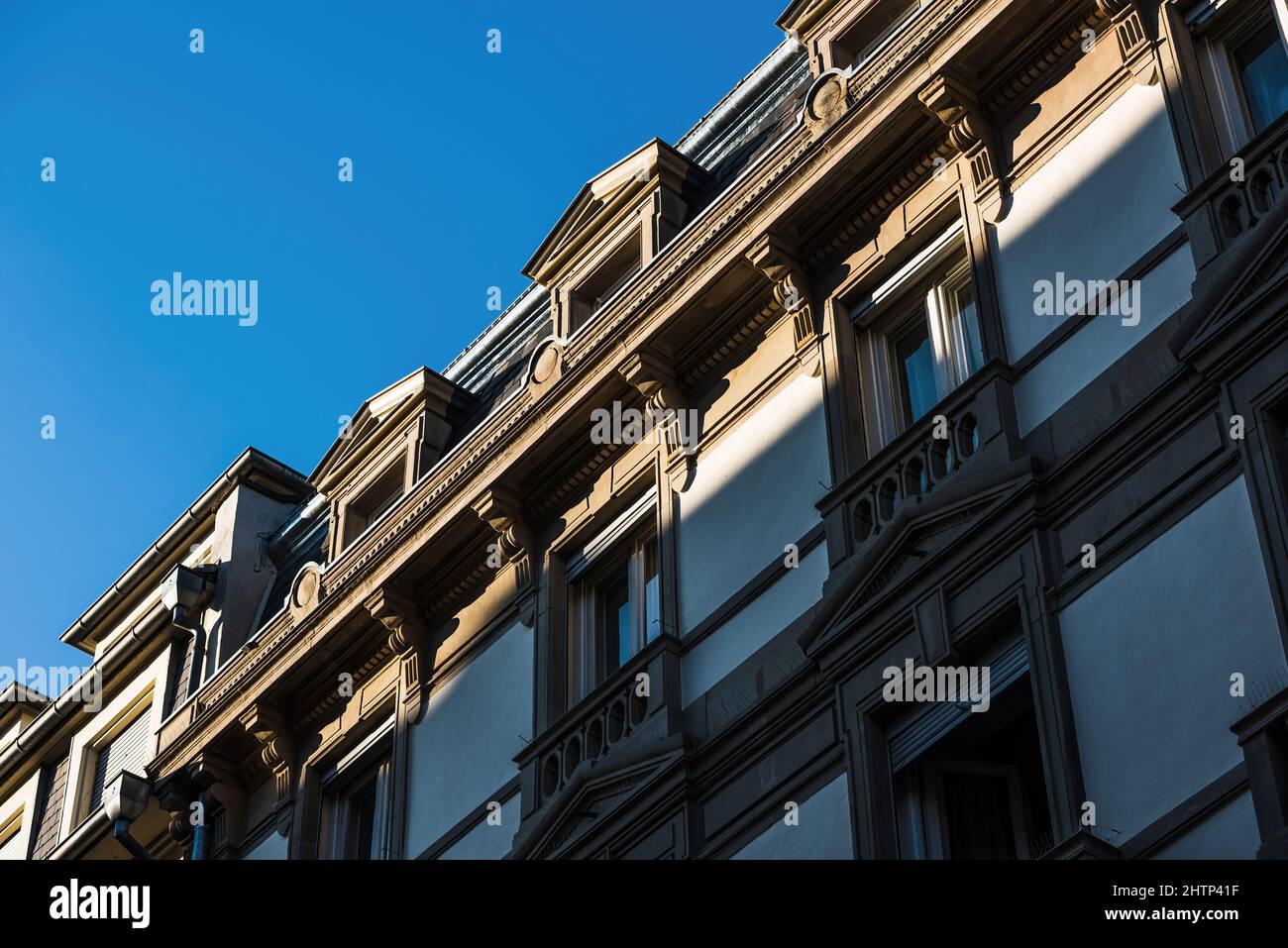 Low side angle view of luxury French patent building with mansard ...