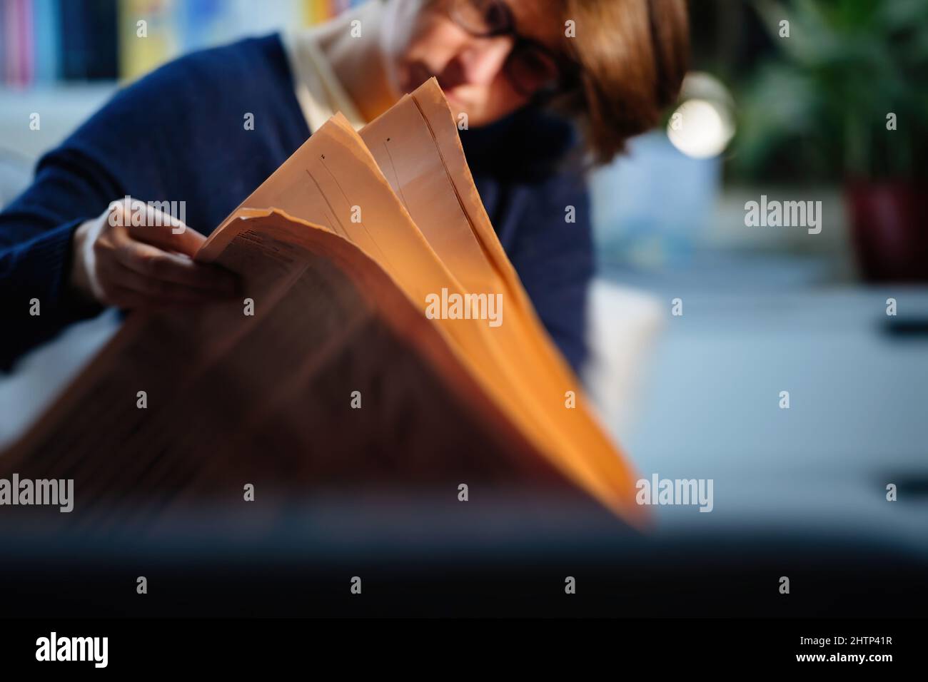 Woman reading in the evening room latest newspaper - reading breaking ...
