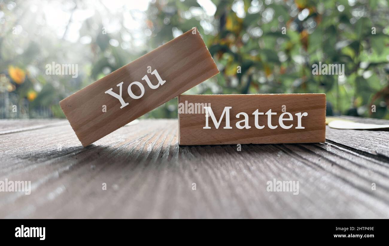 You matter text on wooden blocks with bright sun and park background ...