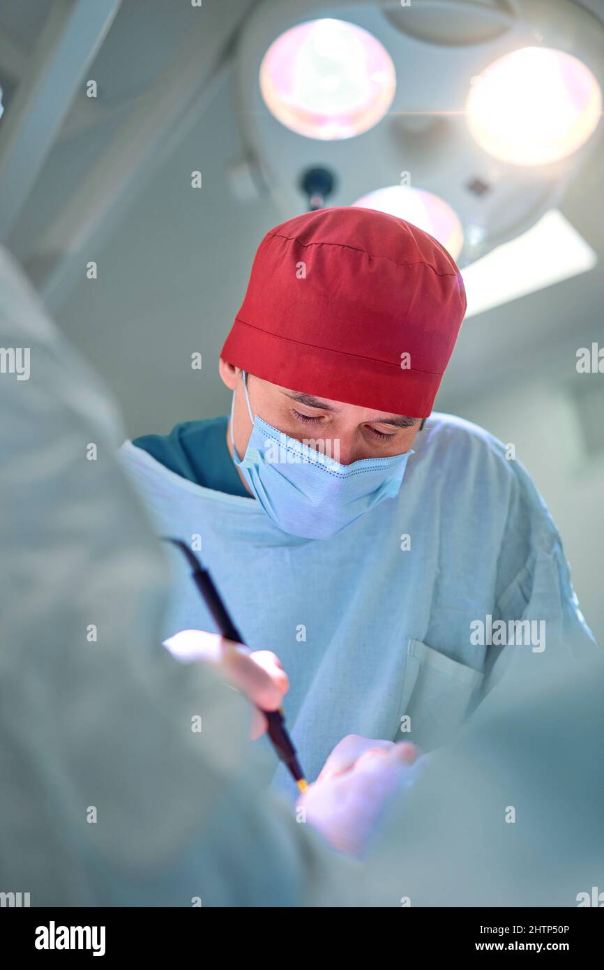 surgeon in the operating room performs an operation on a patient Stock ...