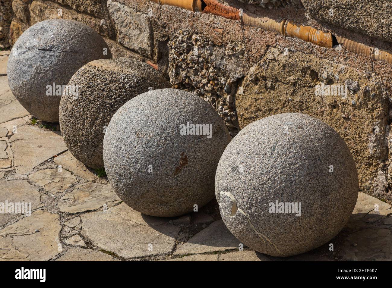 decorative smooth stone spheres along the facade of the building and ...