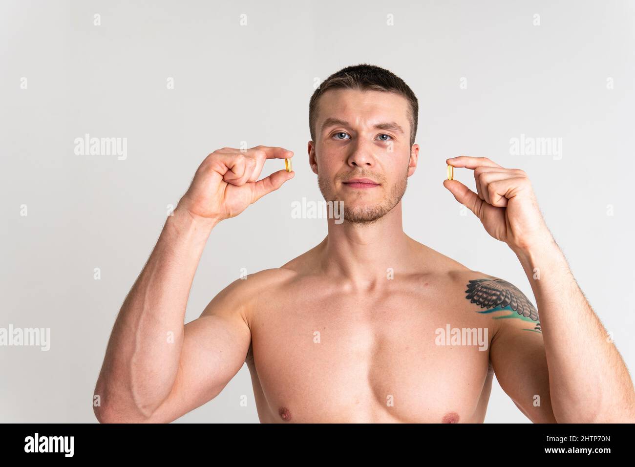 Fish oil is eaten by a man in the hands of vials and a glass bottle ...