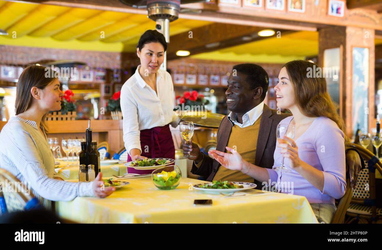 Asian waitress brought tray with restaurant guests Stock Photo - Alamy