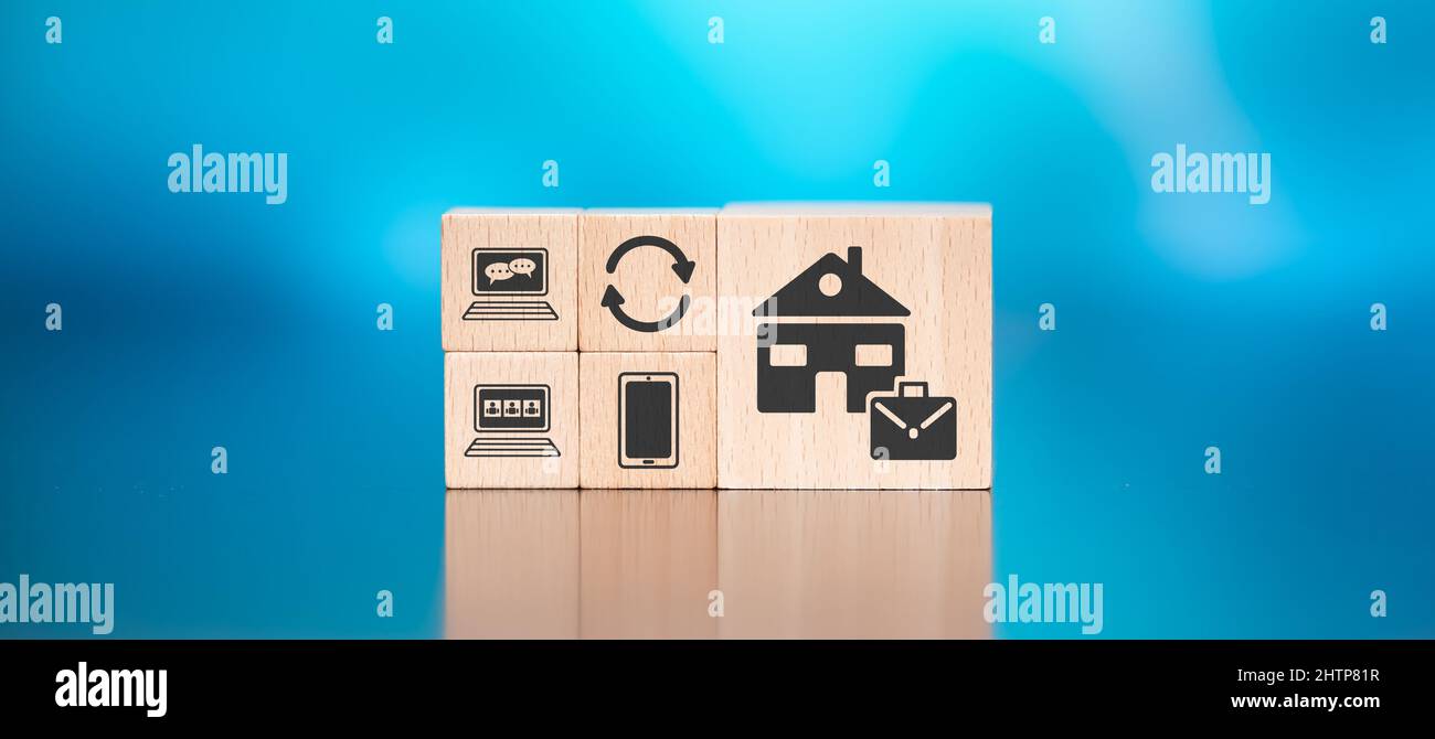 Wooden blocks with symbol of work from home concept on blue background ...