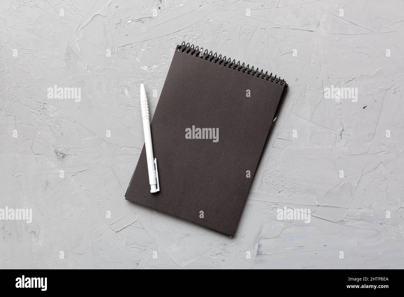 school notebook on a colored background, spiral black notepad on a ...