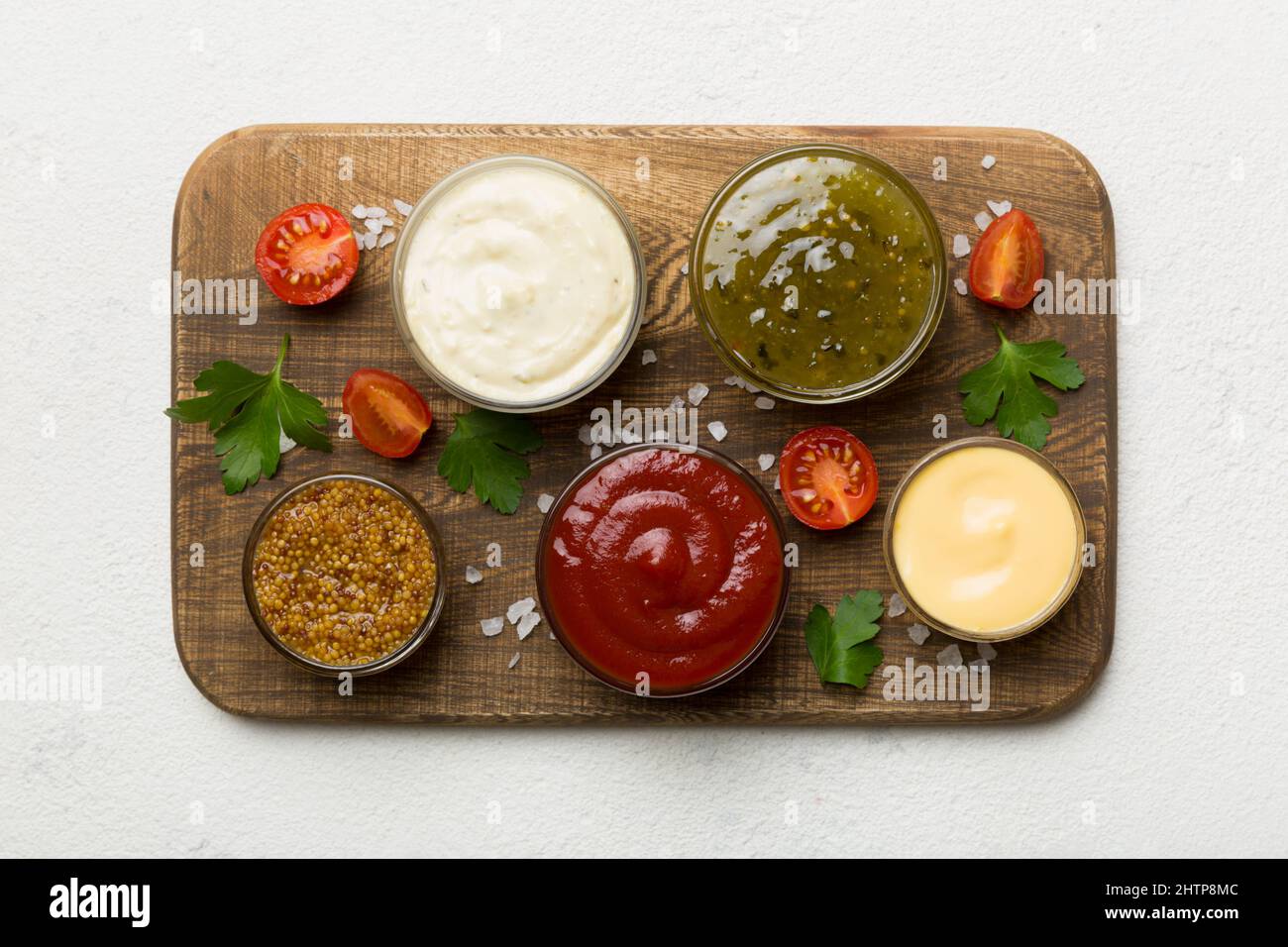 Many different sauces and herbs on table, flat lay top view. sauces on ...