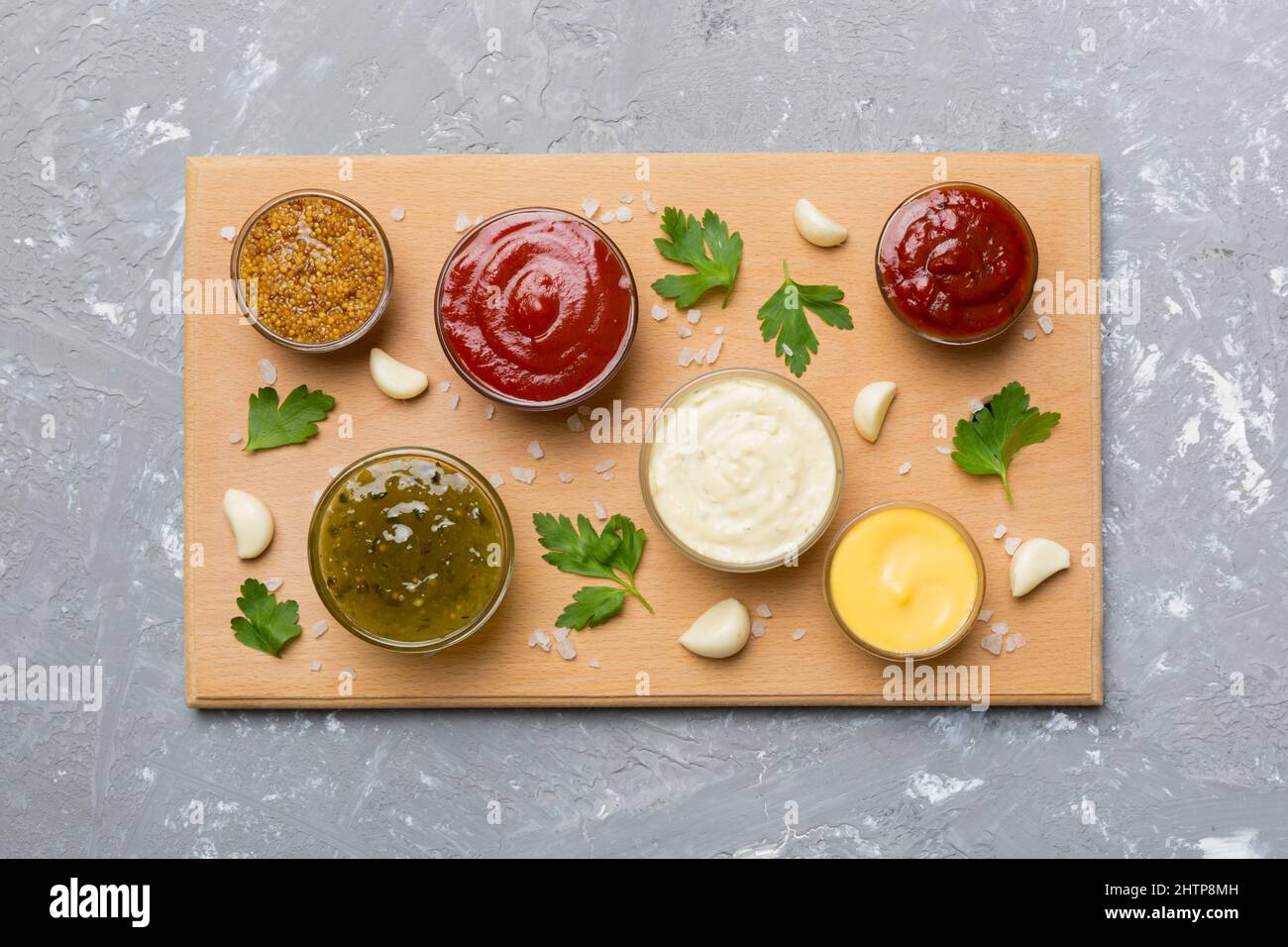 Many different sauces and herbs on table, flat lay top view. sauces on ...