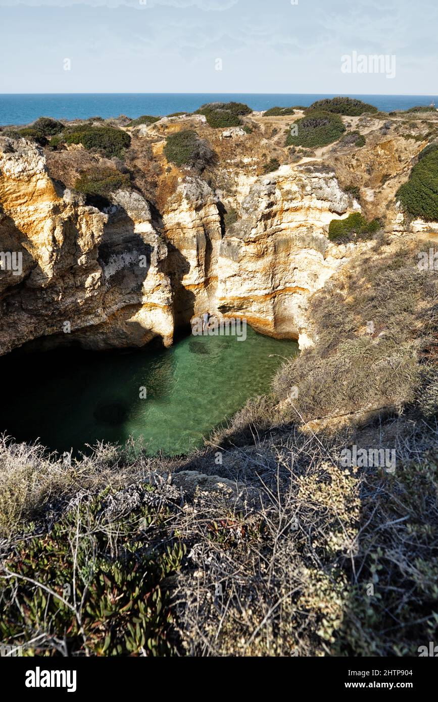 Vertical shot of a lake surrounded by cliffs Stock Photo - Alamy