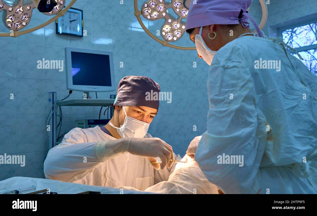 surgeon in the operating room performs an operation on a patient Stock ...