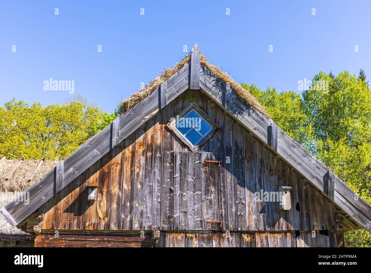 Gable on a old wooden farmhouse with a window Stock Photo - Alamy