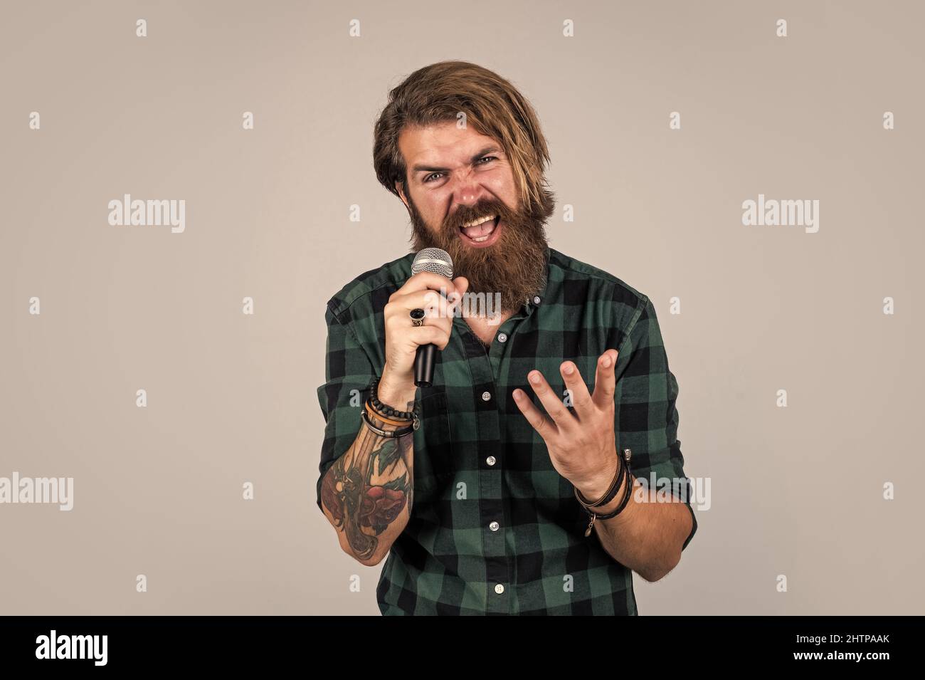 karaoke concept. bearded man in checkered shirt sing a song. casual guy ...