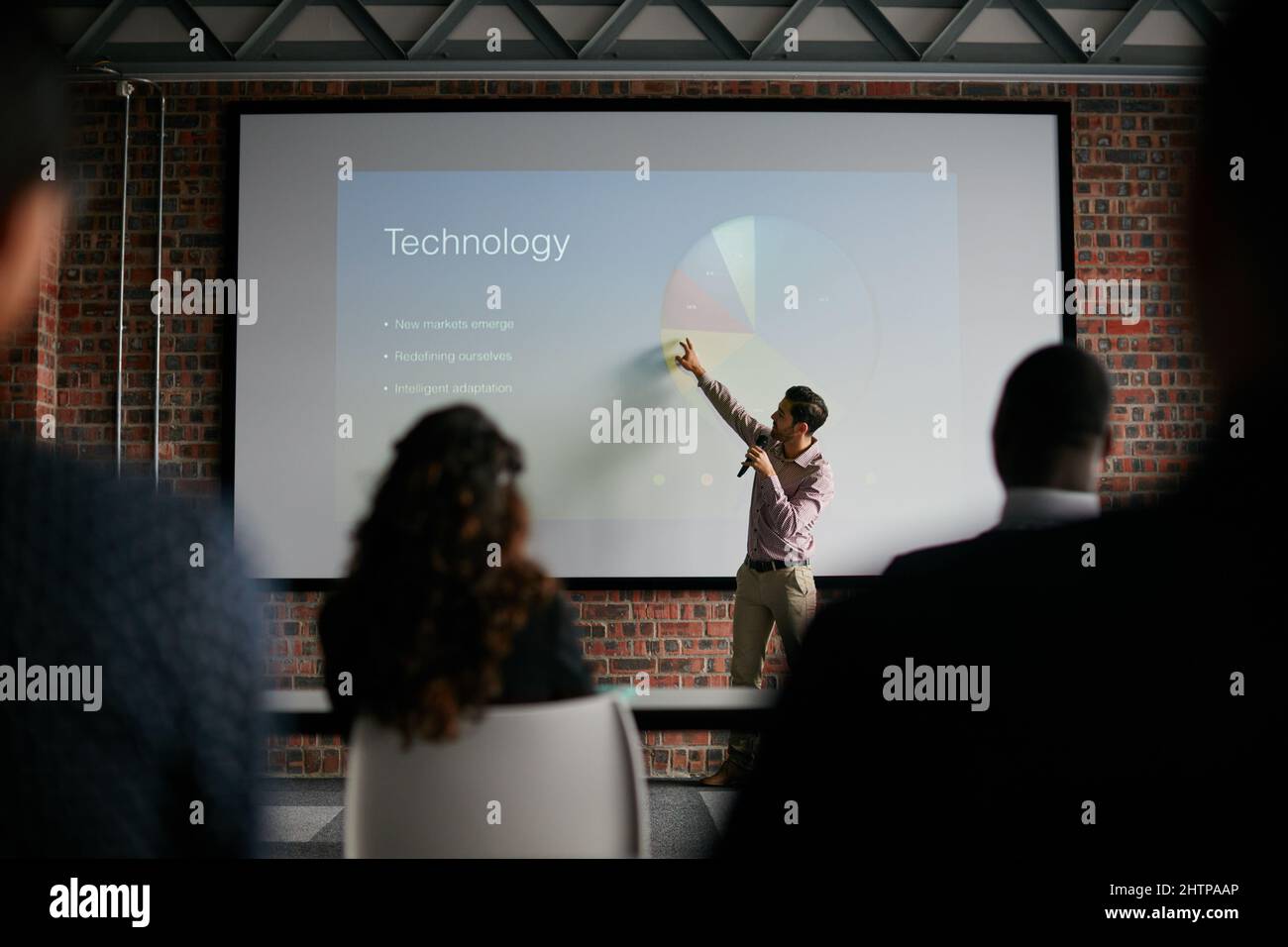 Presenting key notes to his colleagues. Shot of a businessman giving a ...