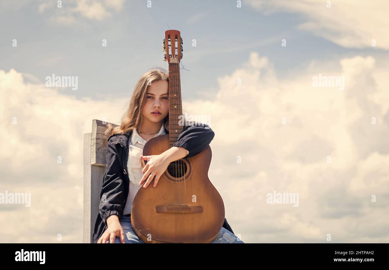 cute kid with acoustic guitar outdoor, music Stock Photo - Alamy