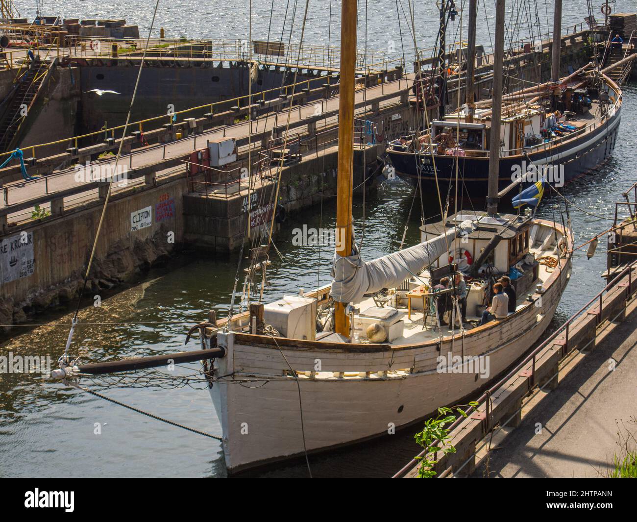 Closeup of two old small schooners in a dock Stock Photo - Alamy