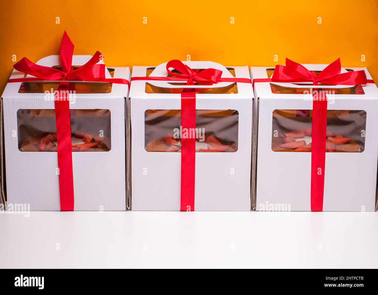 Three homemade cakes in holiday packaging Stock Photo - Alamy