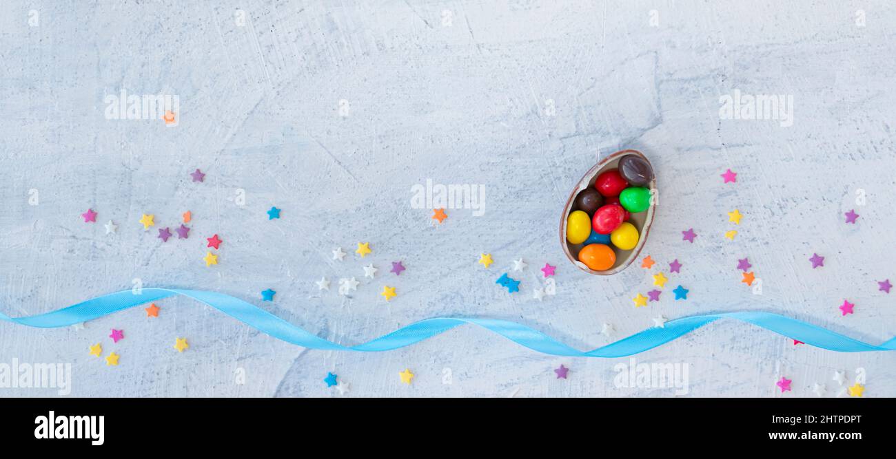 banner with candy in the shape of an egg filled with multi-colored ...