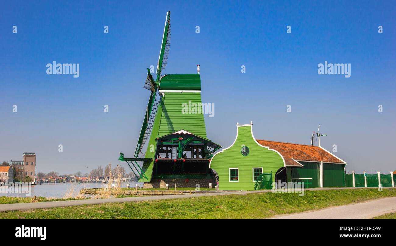 Colorful windmill at the Zaan river in Zaanse Schans, Netherlands Stock ...