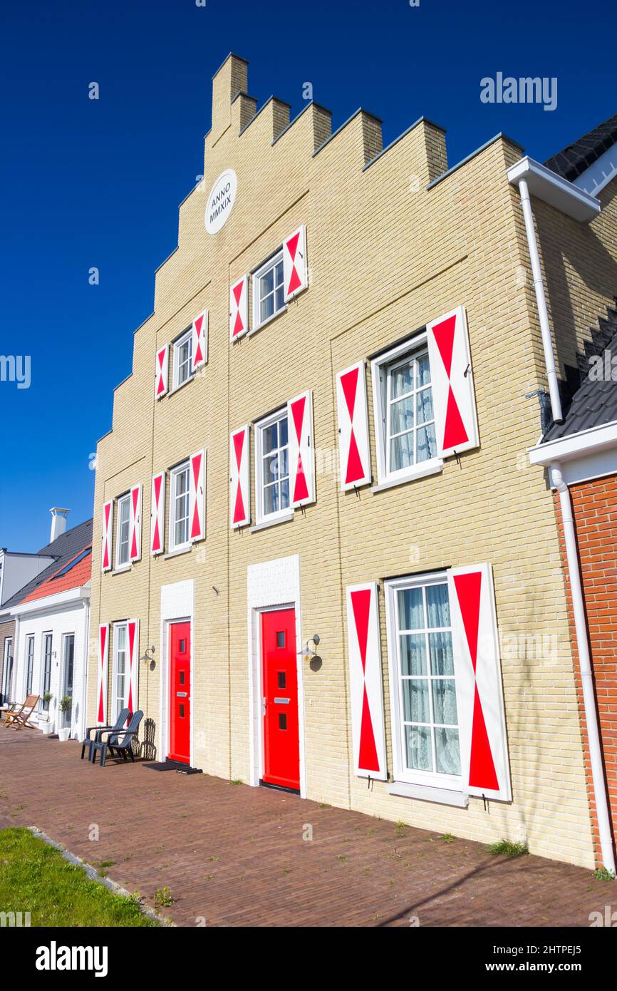 Step gable on a modern house with red doors in Blauwestad, Netherlands ...