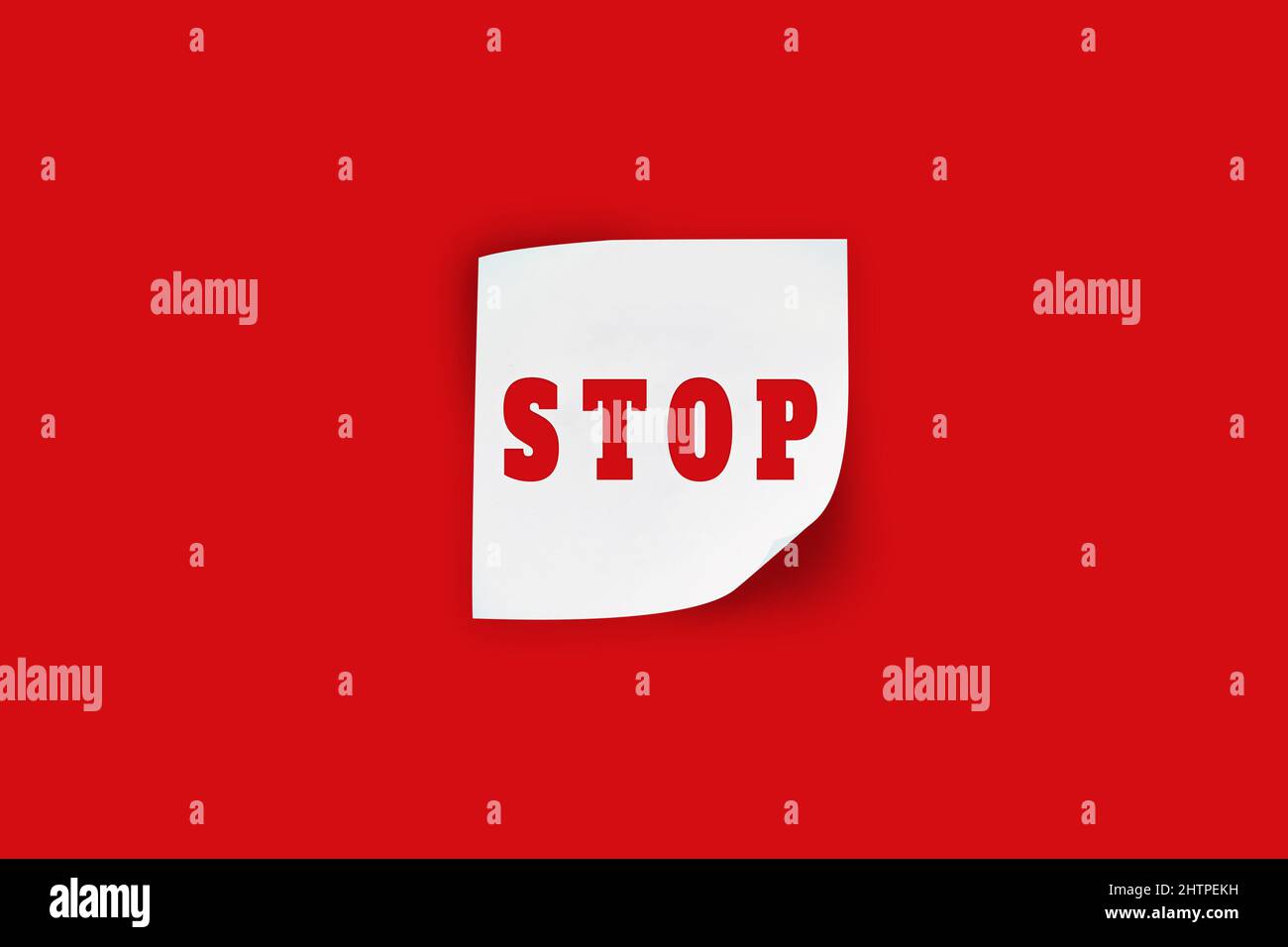 Word stop on sticker on red background Stock Photo - Alamy