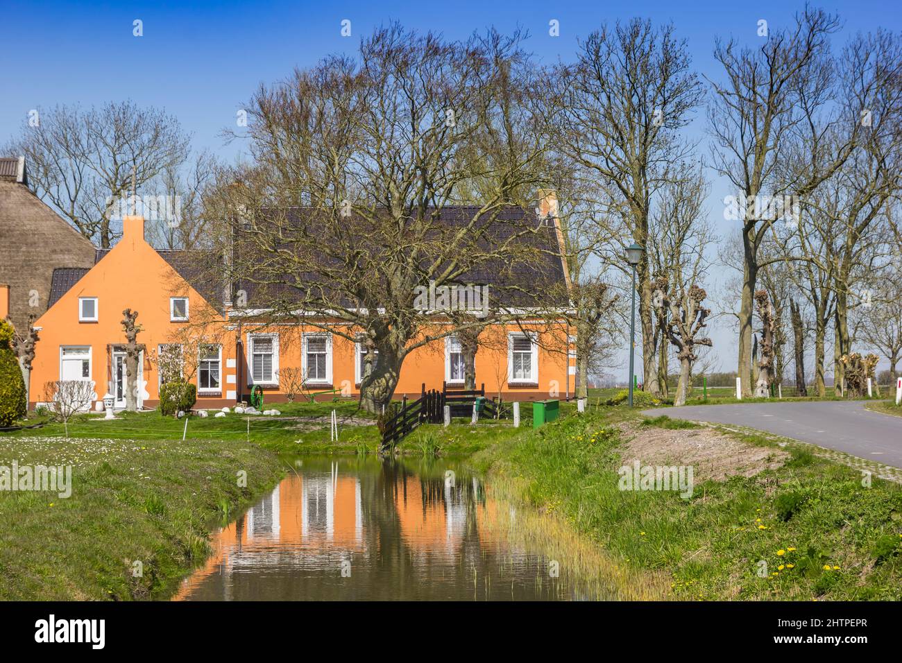 Colorful farmhouse refleted in the water in Den Horn, Netherlands Stock ...