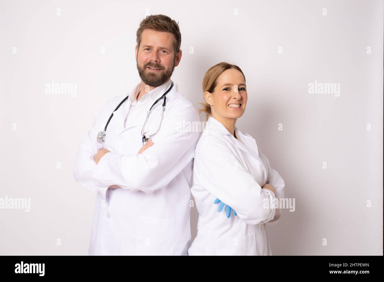 Caucasian doctors partners couple wearing medical uniform over isolated ...