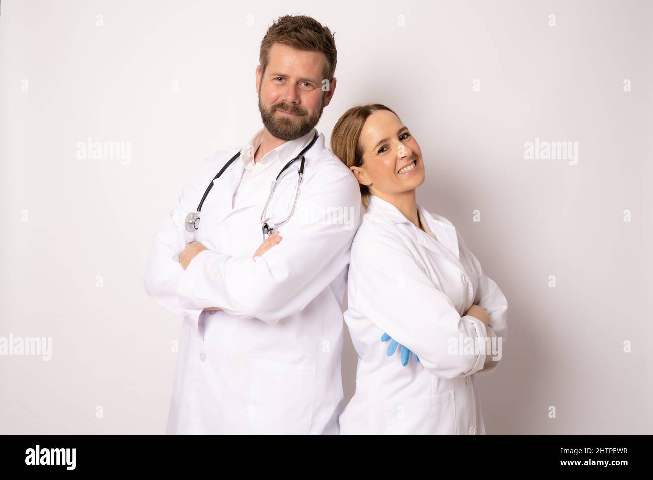 Caucasian doctors partners couple wearing medical uniform over isolated ...