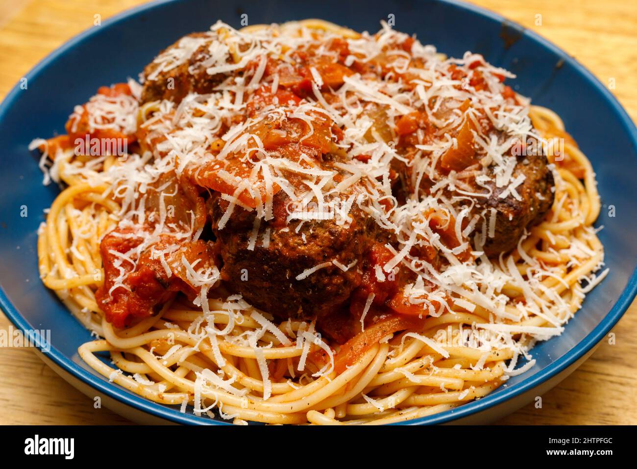Dish of Beef meatballs and spaghetti with a marinara sauce and parmesan ...