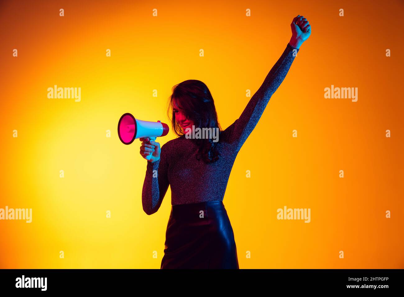 Beautiful young excited girl, student shouting at megaphone isolated on ...