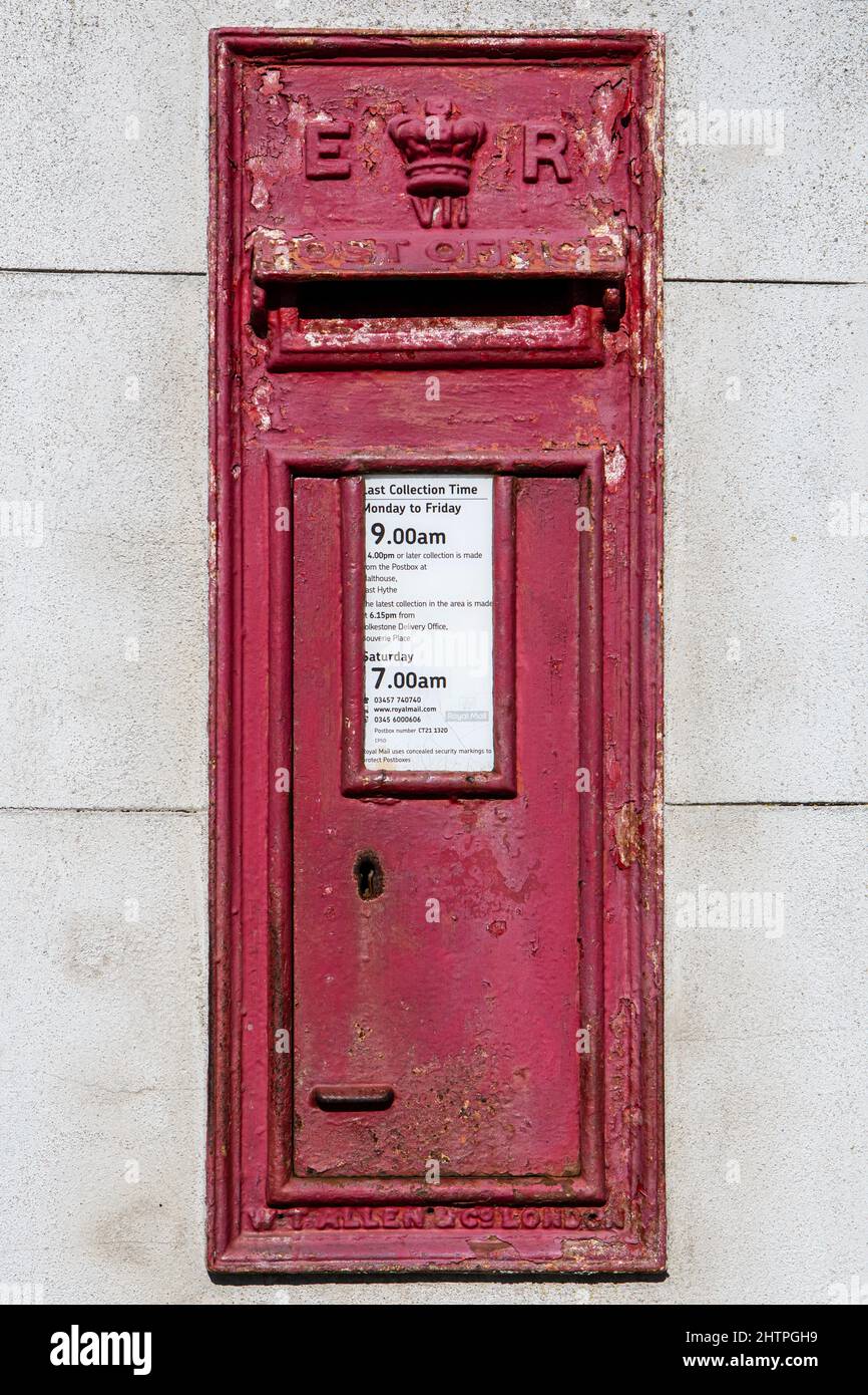 A worn red ER wall mounted letter box Stock Photo - Alamy