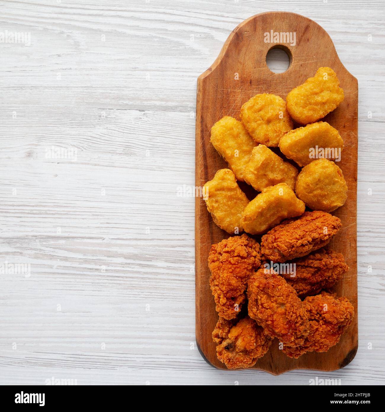 Homemade Crispy Fried Chicken Wings and Nuggets on a rustic wooden ...