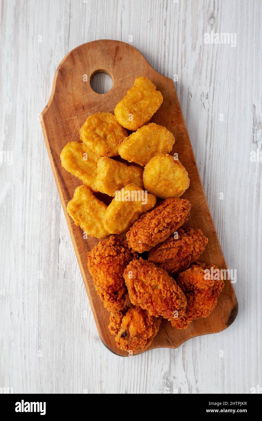 Homemade Crispy Fried Chicken Wings and Nuggets on a rustic wooden ...
