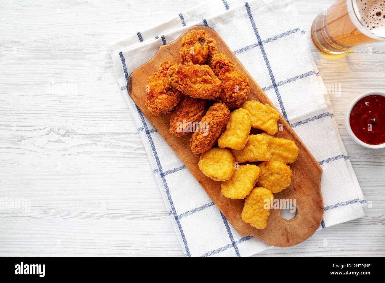 Homemade Crispy Fried Chicken Wings and Nuggets on a rustic wooden ...