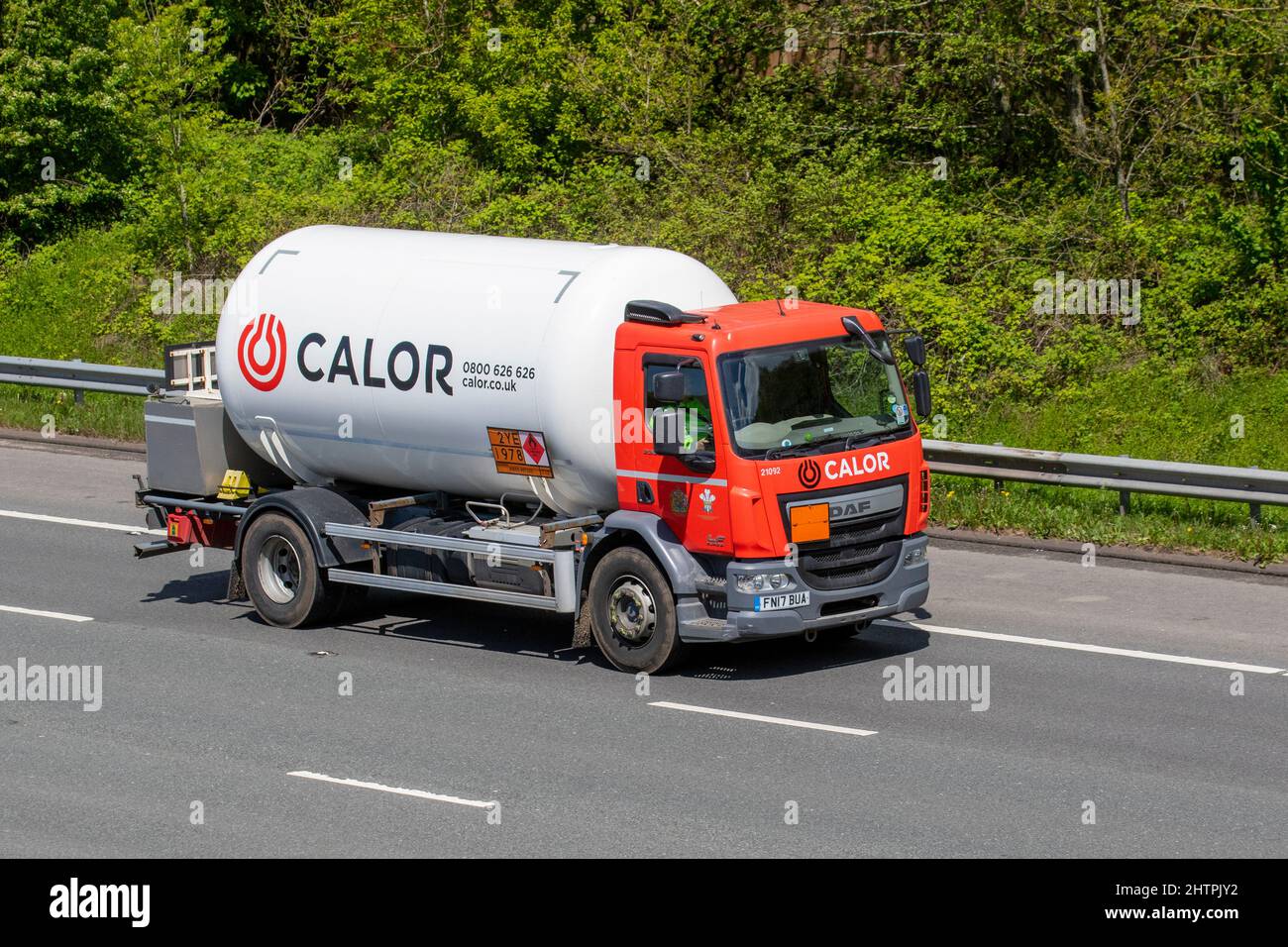 Calor liquid Gas red DAF LF Trucks driving on the M61 motorway, UK ...