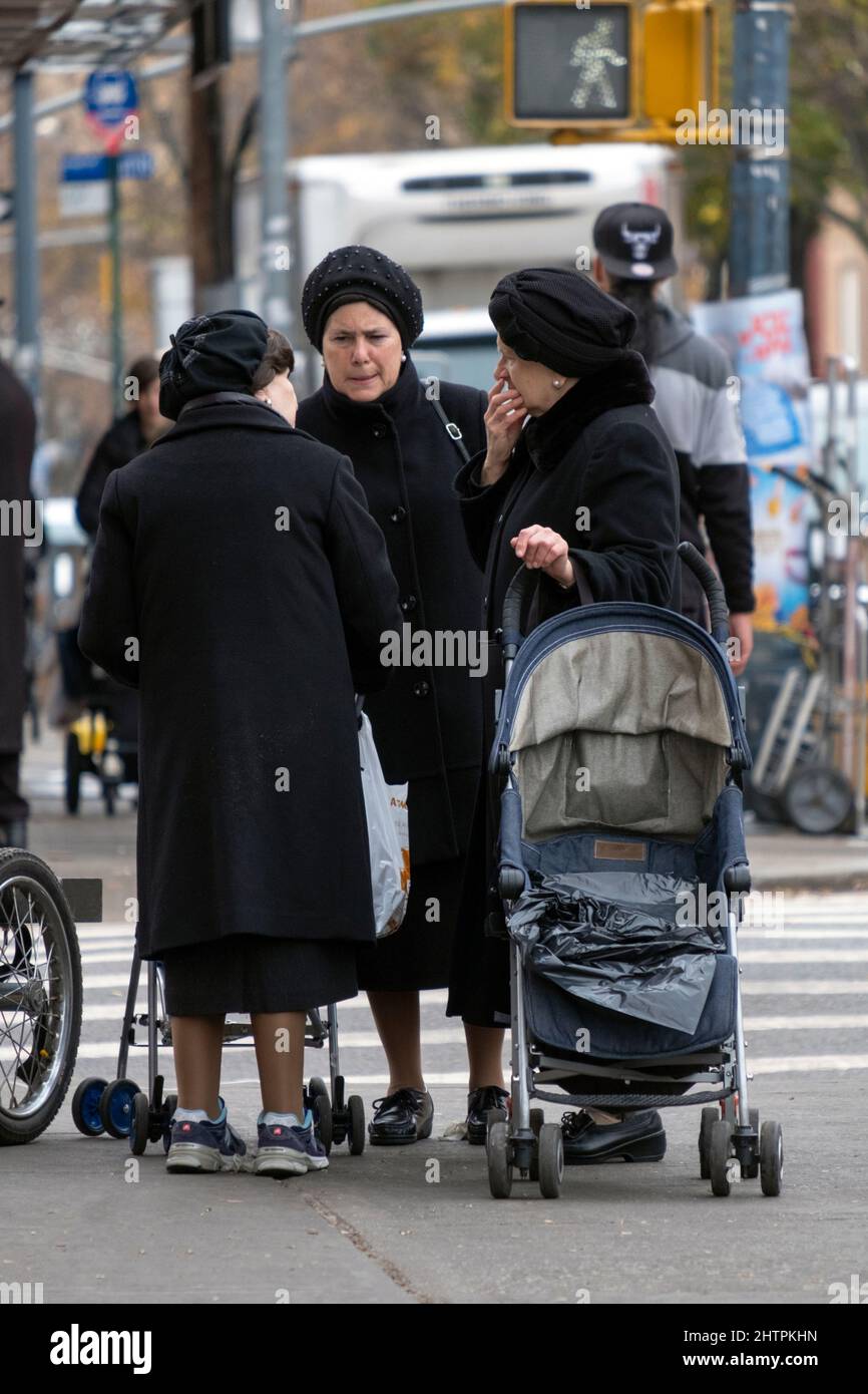 Modestly dressed Hasidic Jewish women have a conversation on Lee Avenue ...