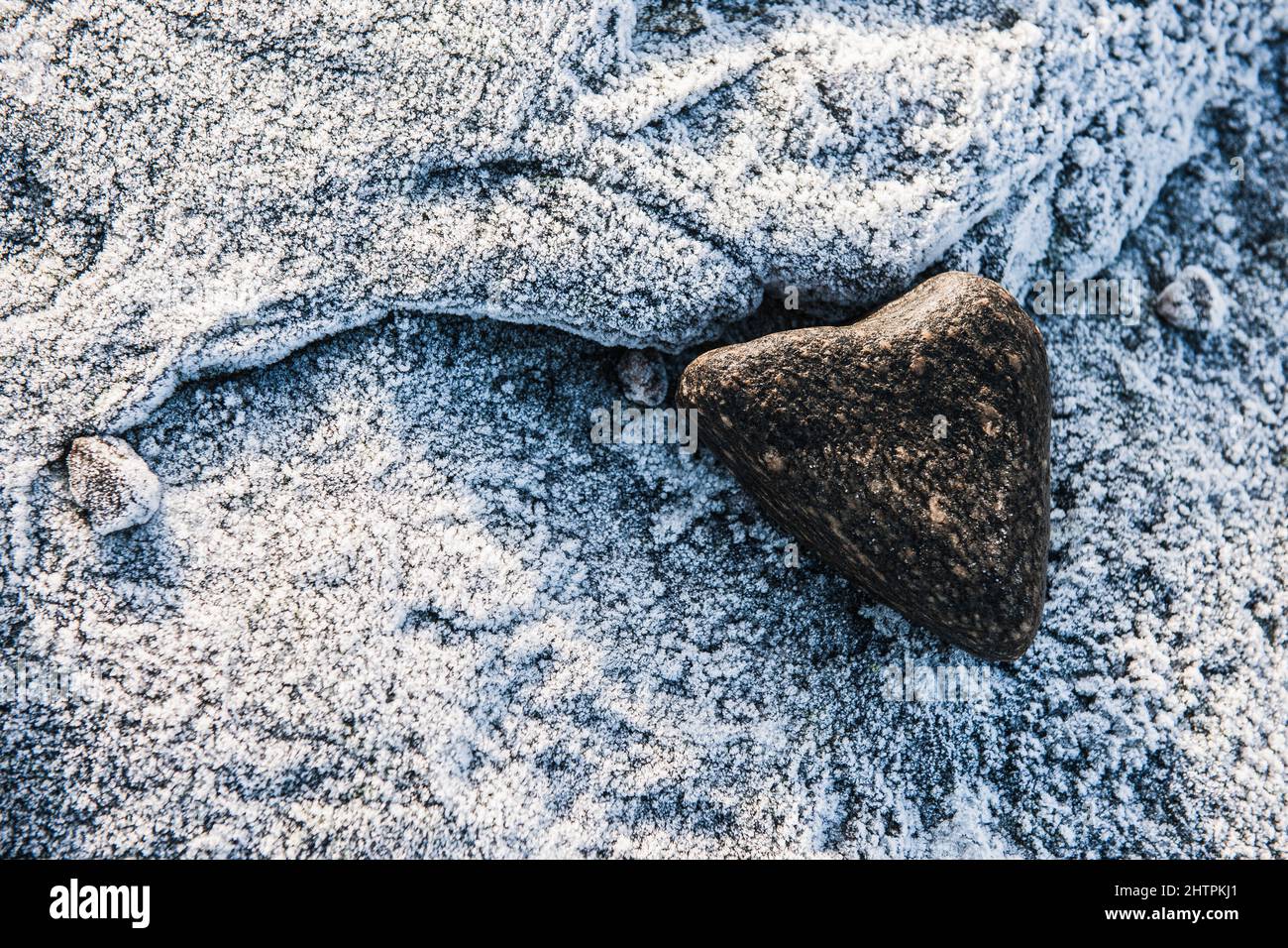 Stone lying on frozen ground Stock Photo - Alamy