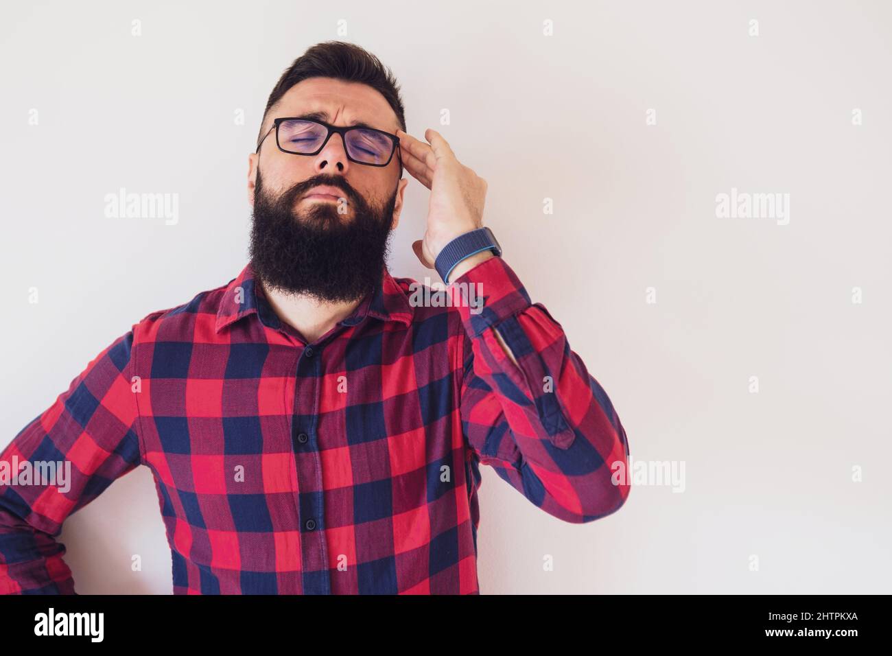 Portrait of man who is tired and having headache. Copy space on image ...